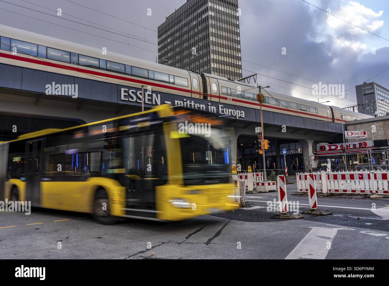 Ruhrbahn bus leaves the bus station at Essen main station, ICE train on ...