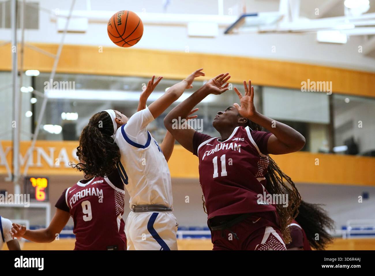Seton Hall guard Jada Eads (0) and Fordham forward Precious Omoshola (11) reach for the ball ...