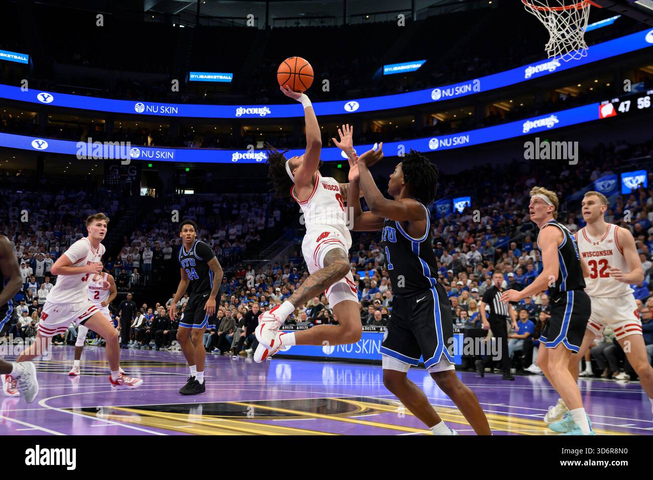 Wisconsin guard Braeden Carrington (0) is fouled by BYU guard Robert ...