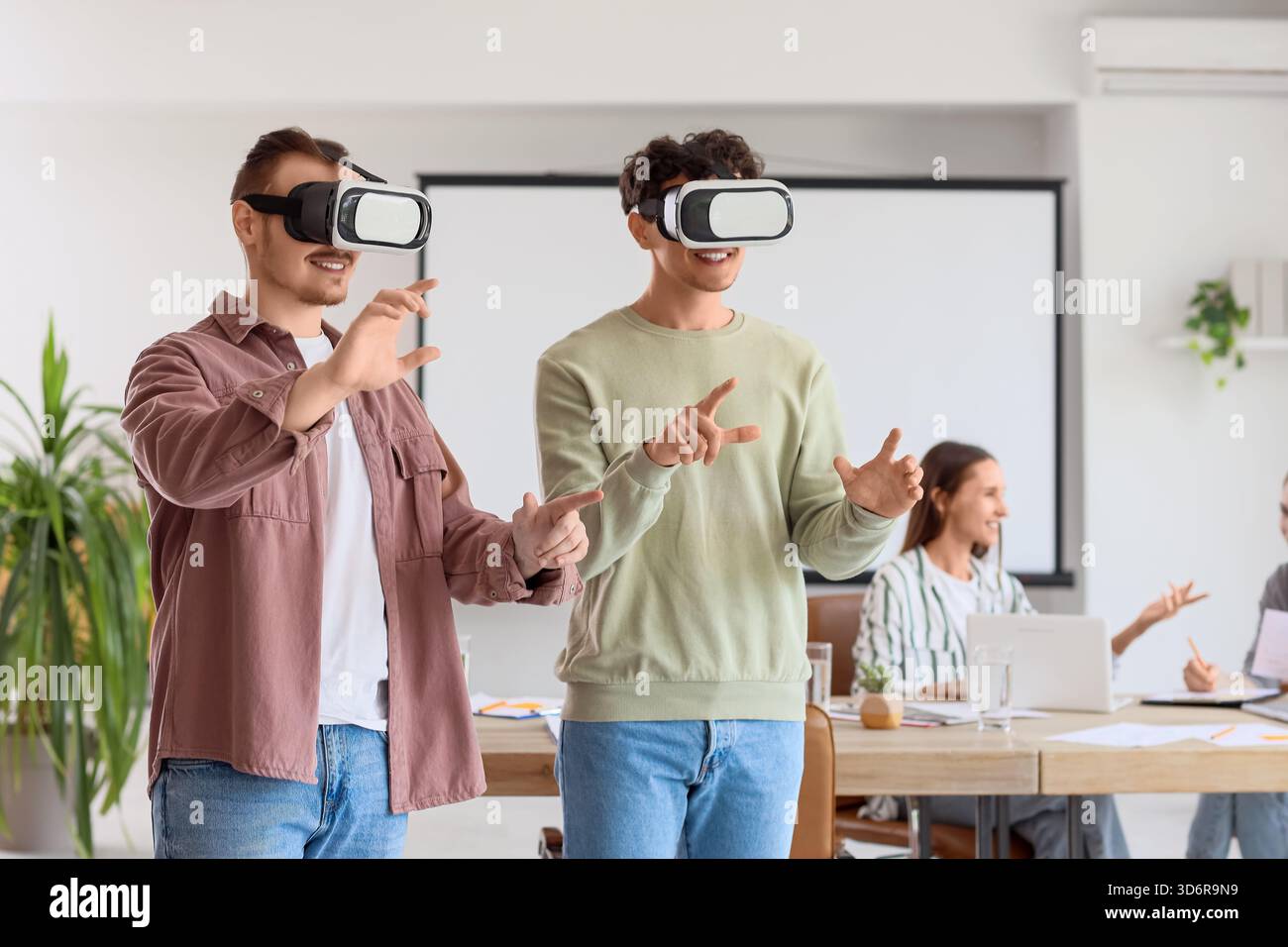 Young men using vr hi-res stock photography and images - Alamy