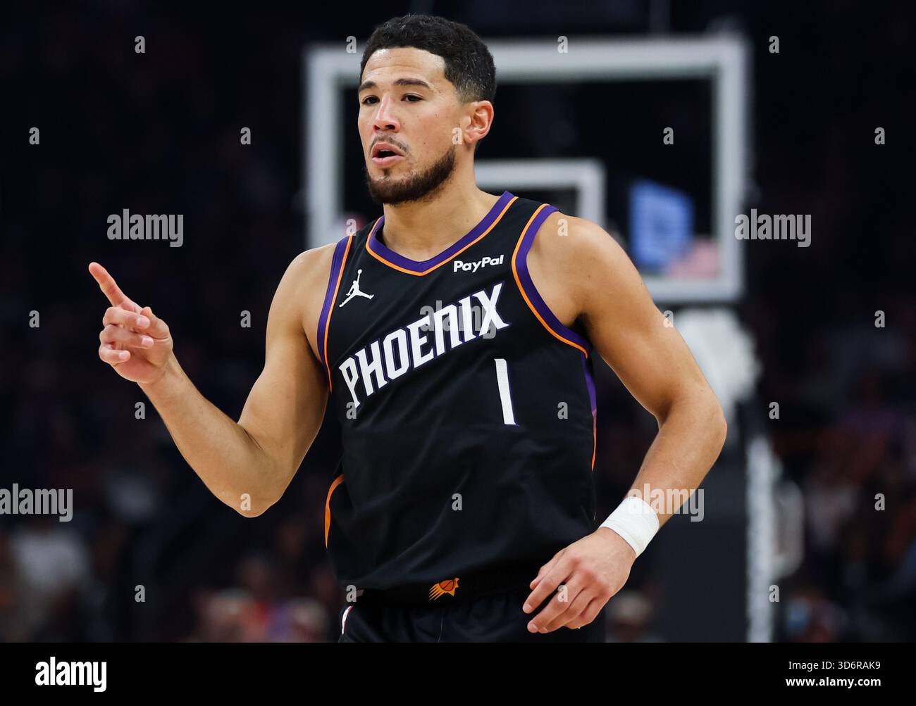 Phoenix Suns guard Devin Booker (1) reacts during the first half of an ...