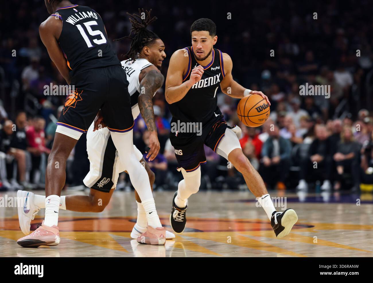 Phoenix Suns guard Devin Booker (1) dribbles around a screen during the ...