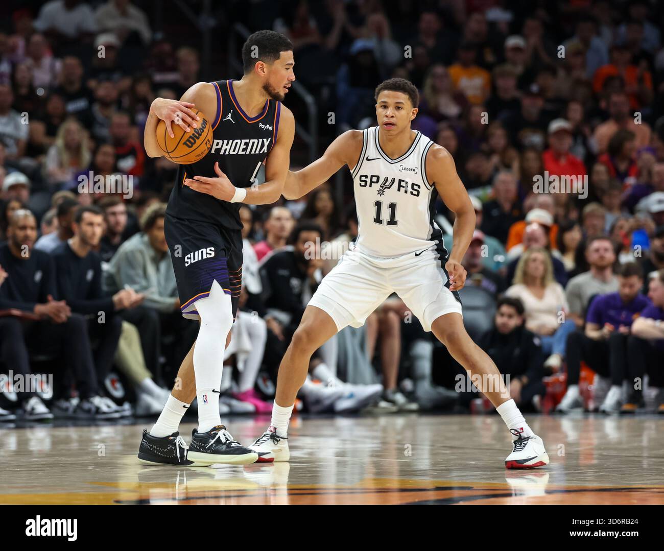 San Antonio Spurs forward Carter Bryant (11) guards Phoenix Suns guard ...