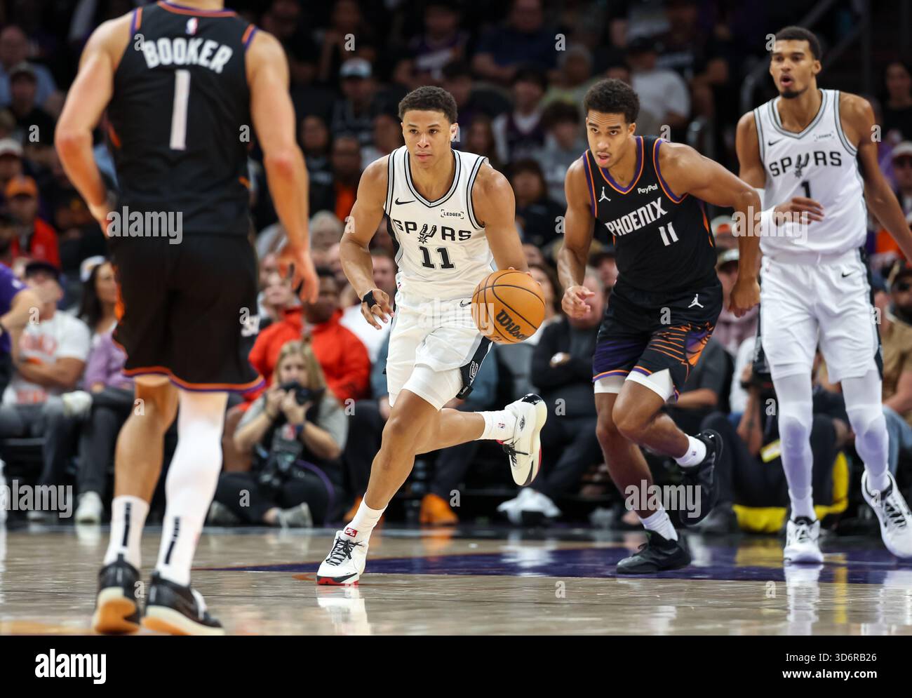 San Antonio Spurs forward Carter Bryant (11) brings the ball upcourt ...