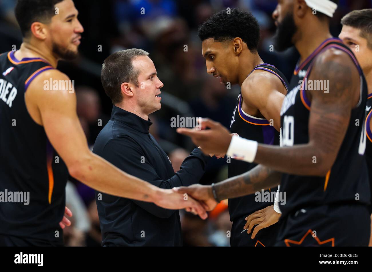 Phoenix Suns head coach Jordan Ott, center left, talks with forward ...