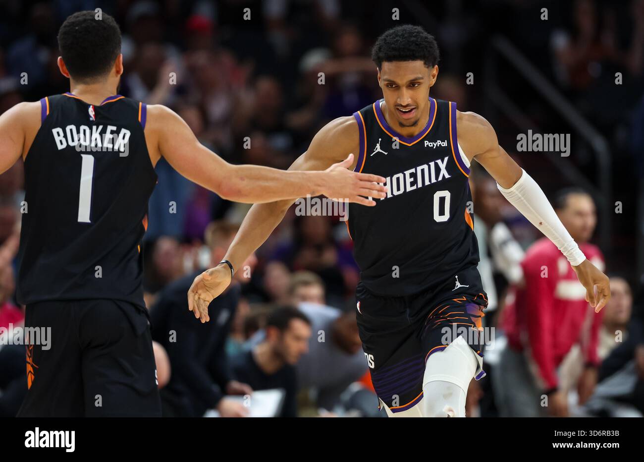 Phoenix Suns forward Ryan Dunn (0) slaps hands with guard Devin Booker ...