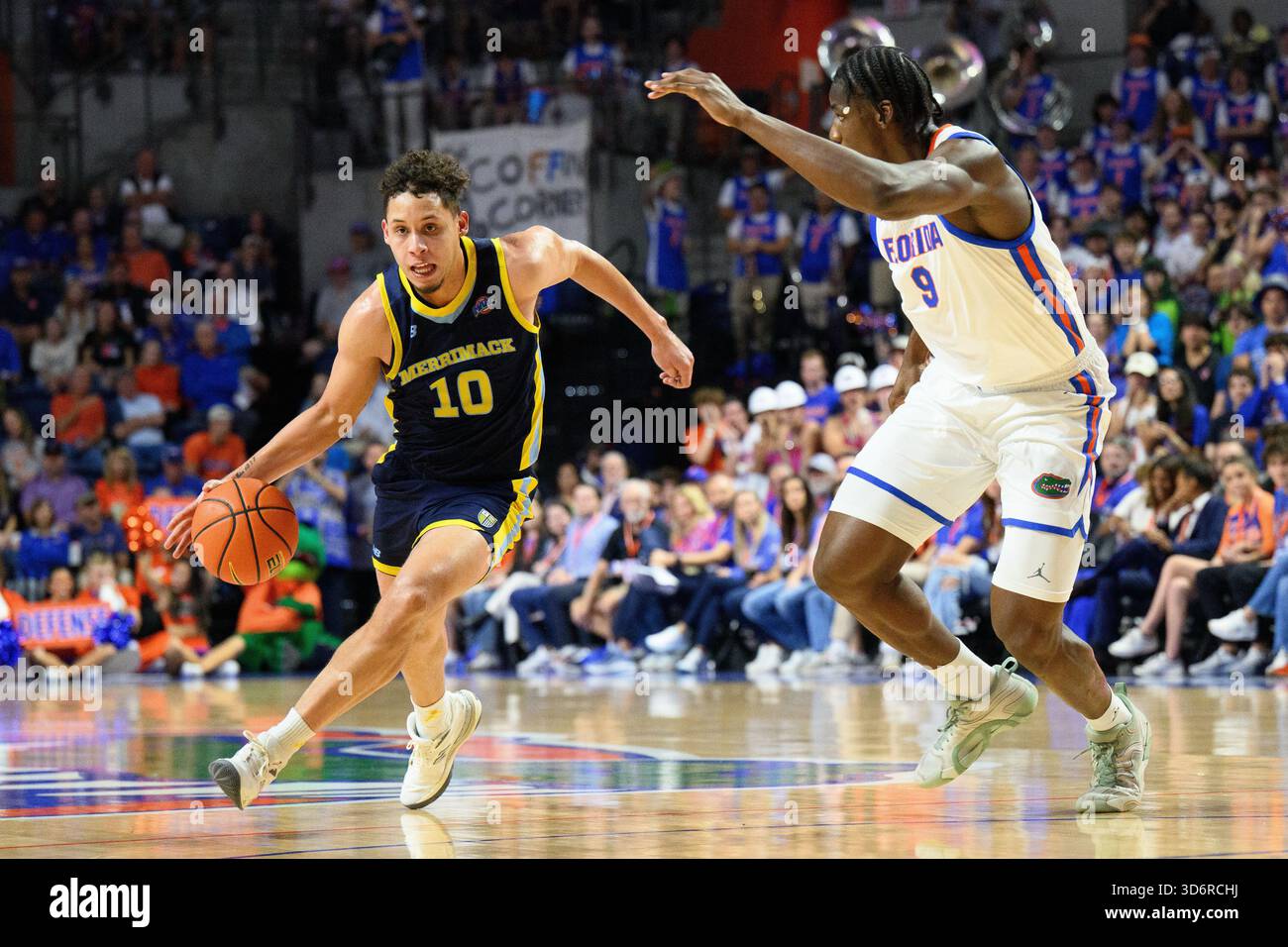 Merrimack guard Andrés Marrero (10) drives on Florida center Rueben Chinyelu (9) during the ...
