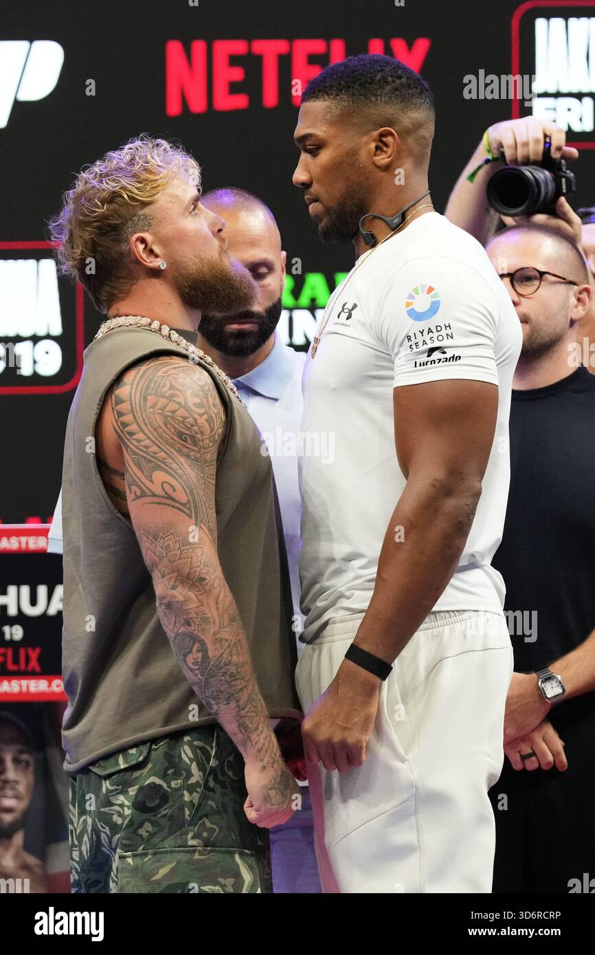 Jake Paul, left, and Anthony Joshua, right, face off during a news ...