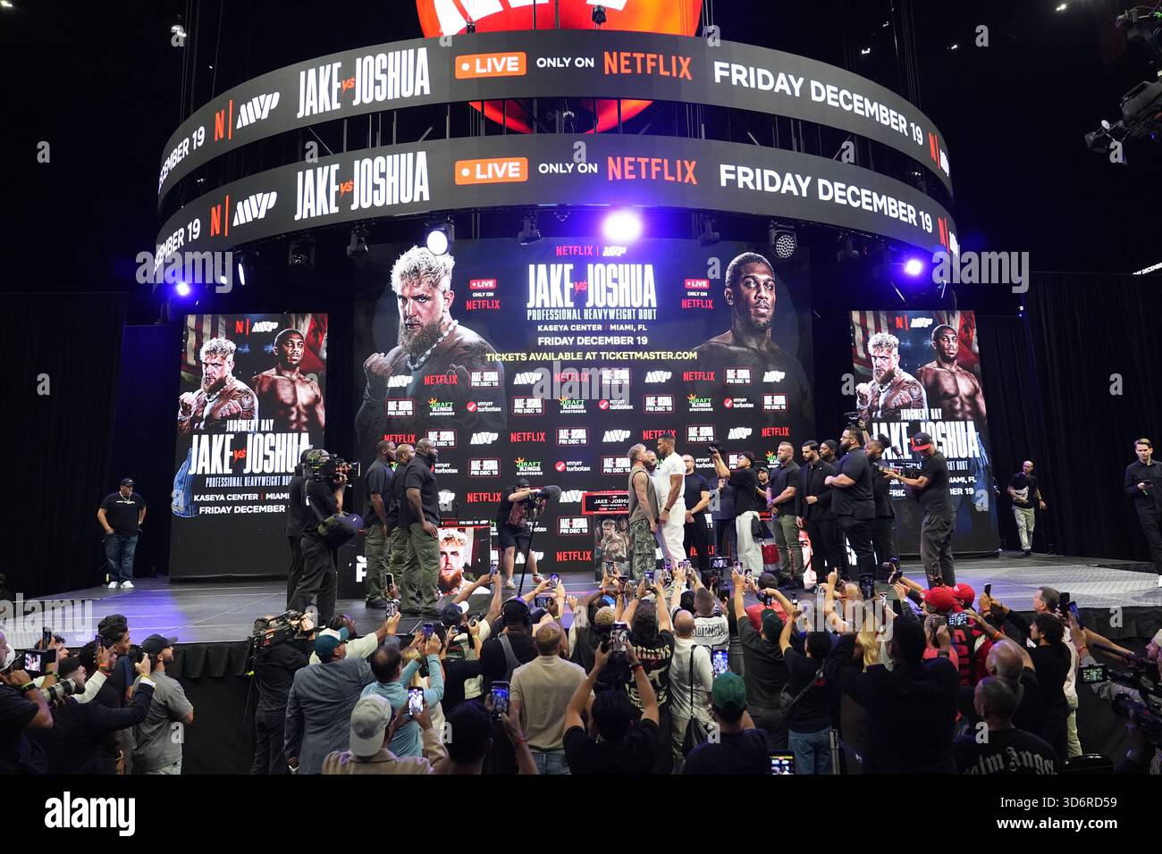 Jake Paul, left, and Anthony Joshua, right, face off during a news ...