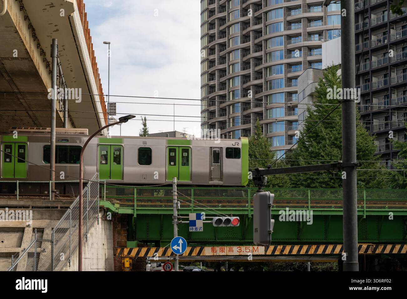 Train passing over a bridge in a modern Japanese city Stock Photo - Alamy