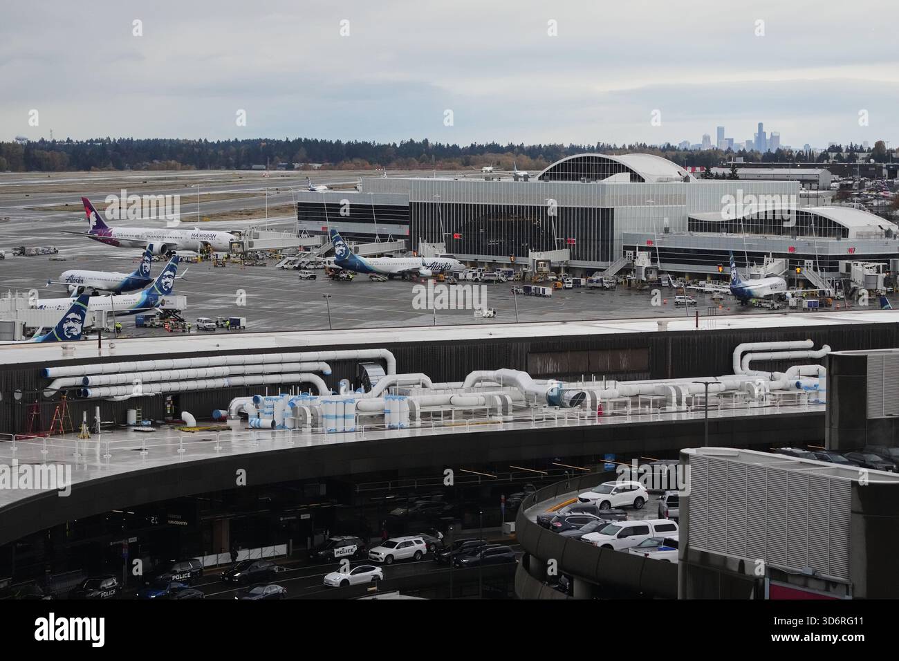 FILE - Hawaiian and Alaska Airlines airplanes are seen parked at gates ...