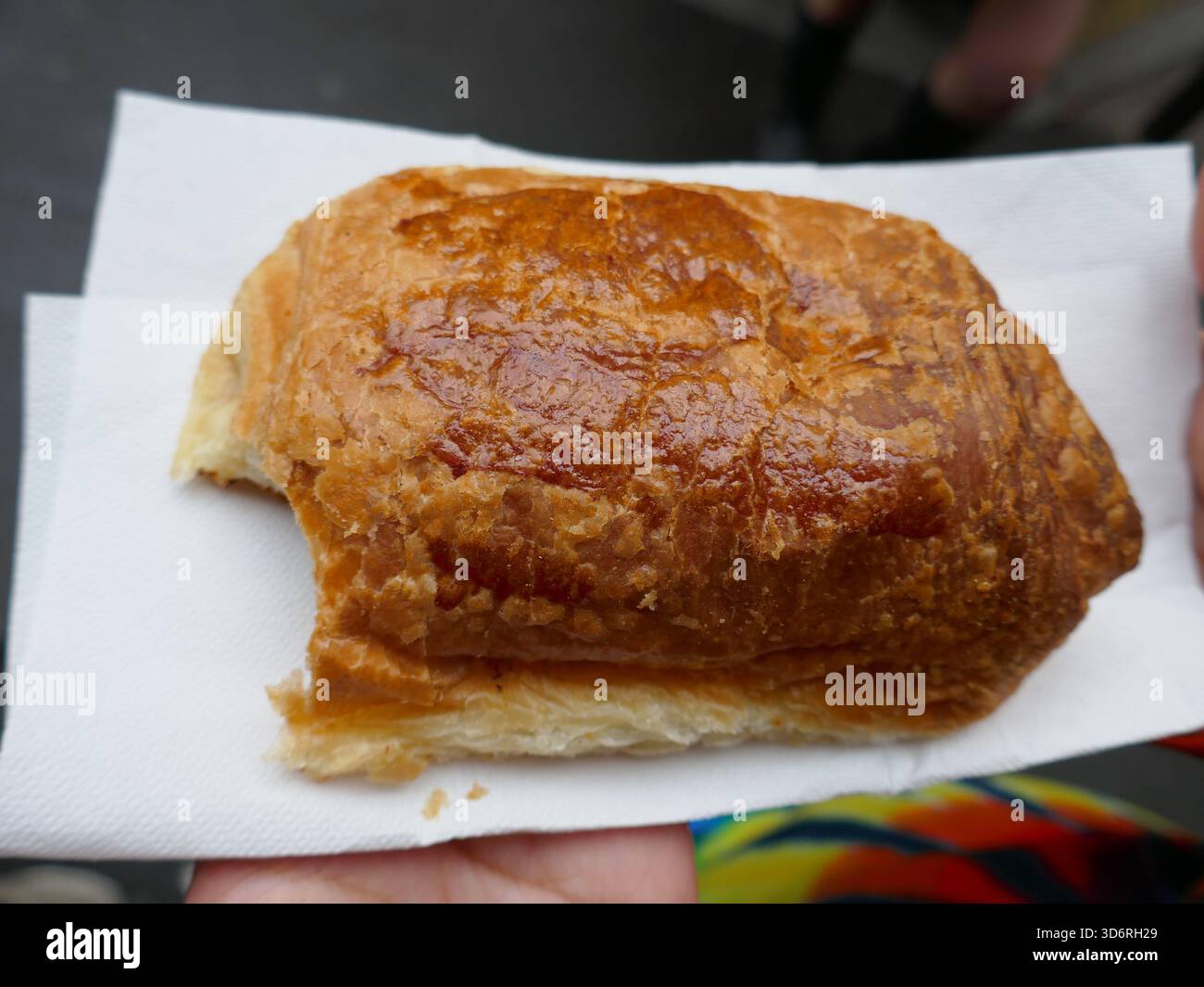 Savory freshly made croissant with bite taken Stock Photo - Alamy