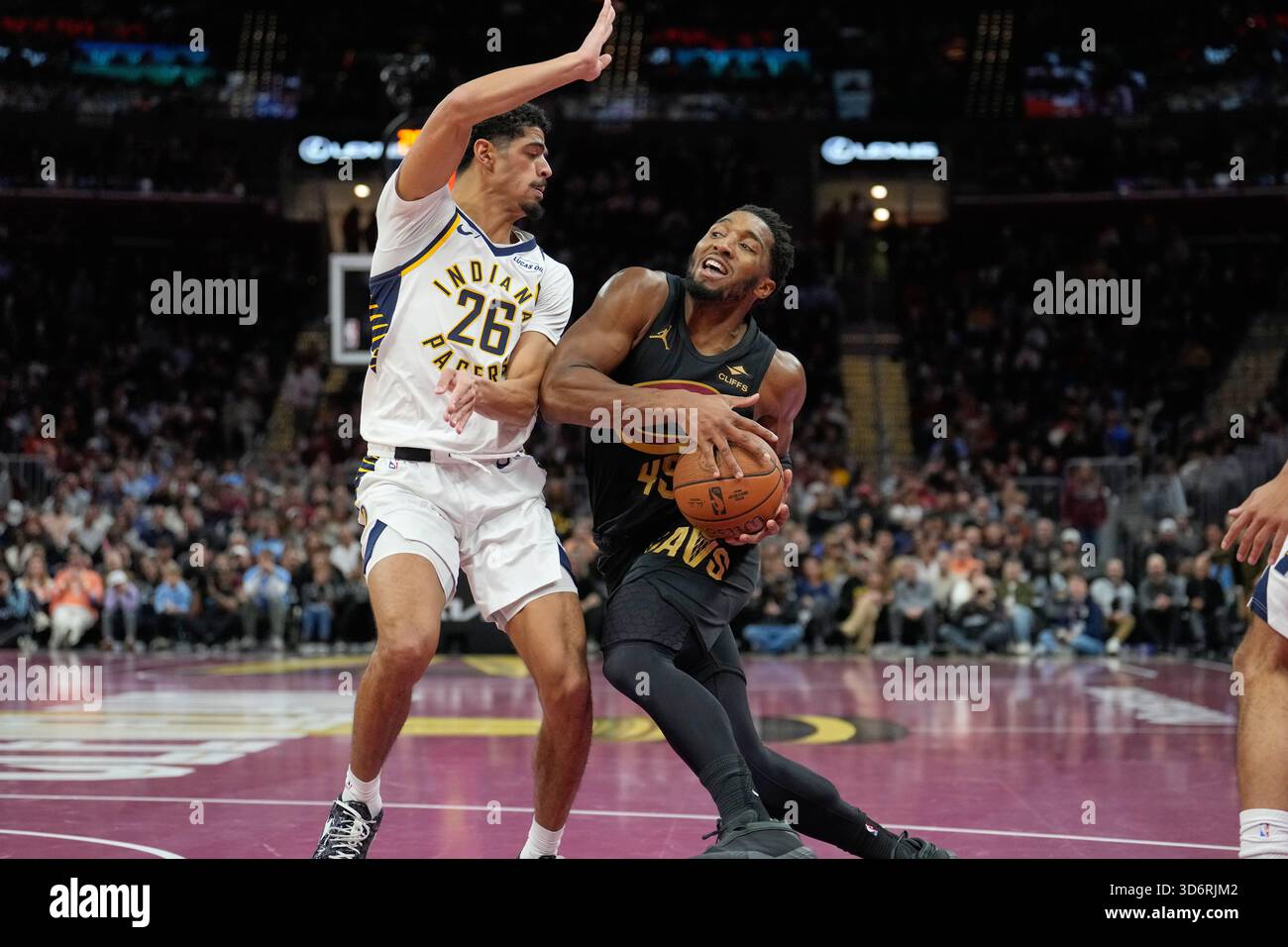 Cleveland Cavaliers guard Donovan Mitchell, right, drives around ...