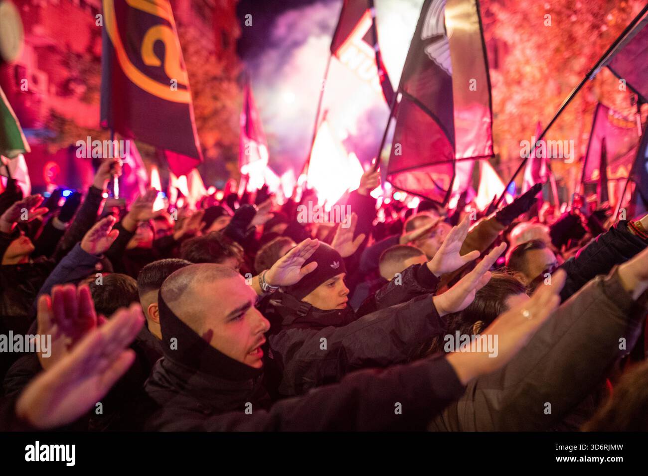 Far-right demonstrators perform the fascist salute amidst flares during ...