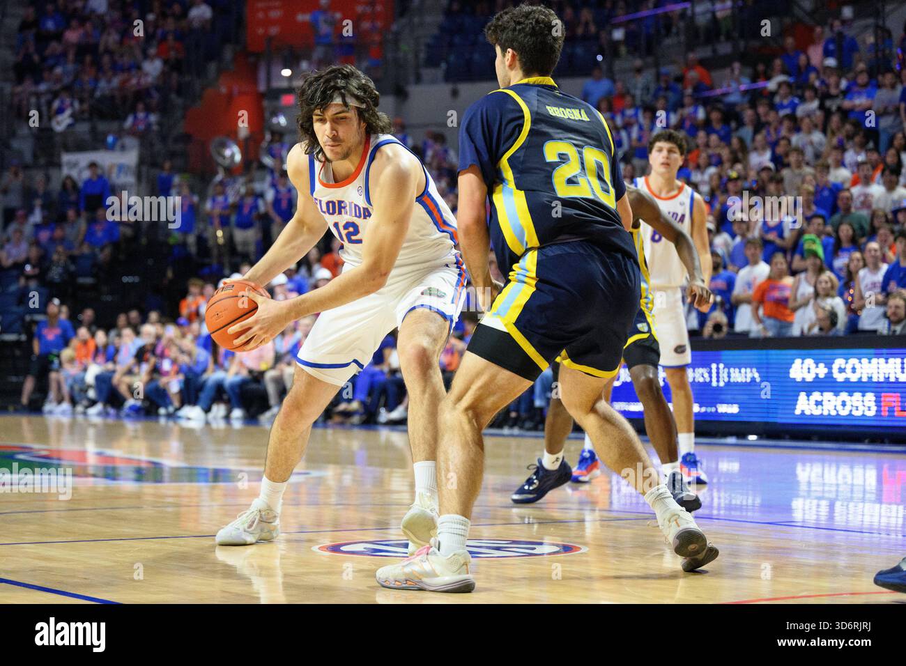 Florida center Viktor Mikic (12) drives against Merrimack forward Todd Brogna (20) during the ...