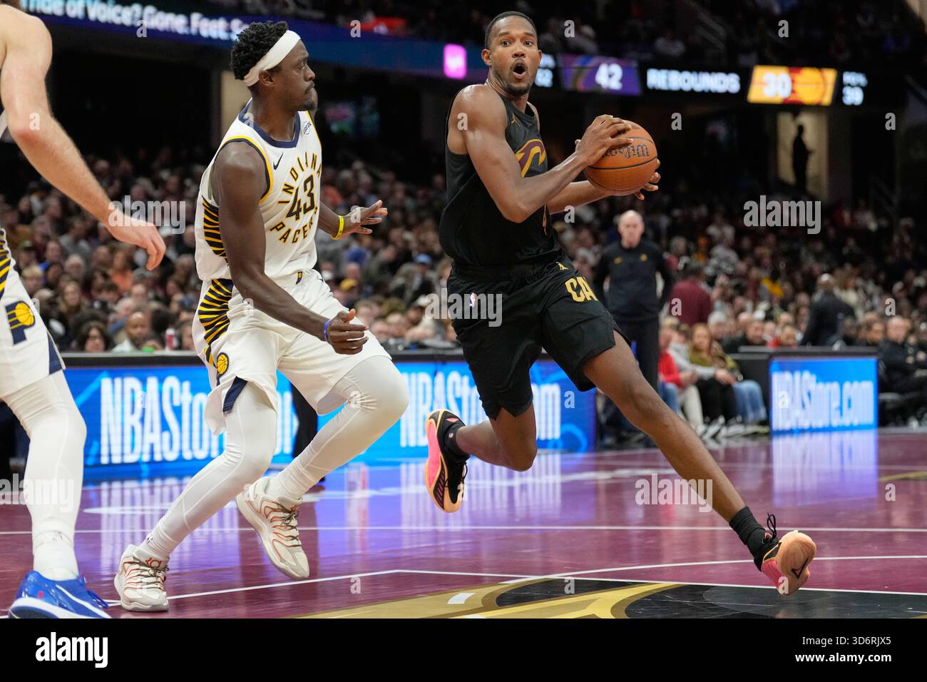 Cleveland Cavaliers center Evan Mobley, right, drives around Indiana ...