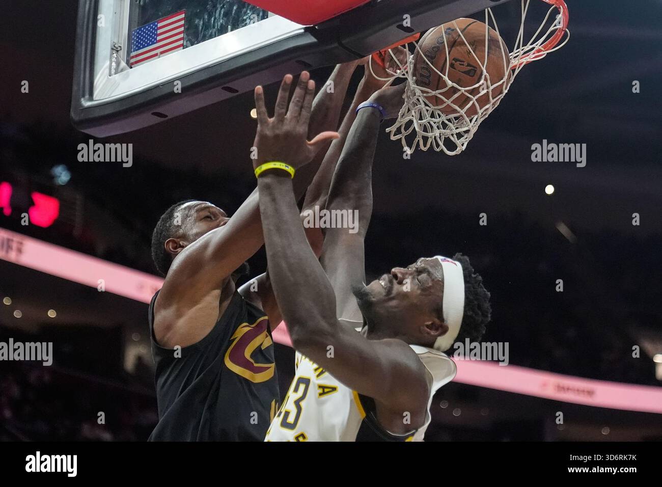 Cleveland Cavaliers center Evan Mobley, left, dunks over Indiana Pacers ...