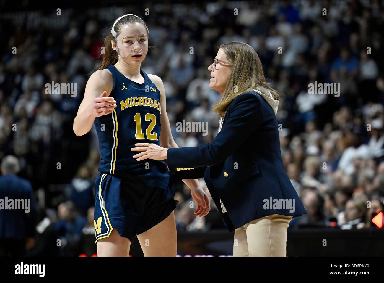 Michigan head coach Kim Barnes Arico talks with Michigan guard Syla ...