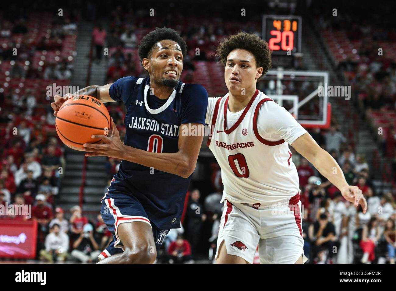 Jackson State guard Tamarion Hoover, left, tries to drive past Arkansas ...