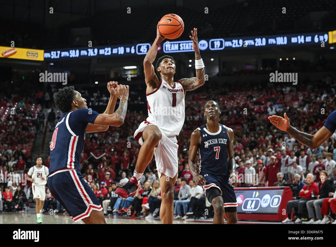 Arkansas guard Meleek Thomas (1) drives past Jackson State defenders ...