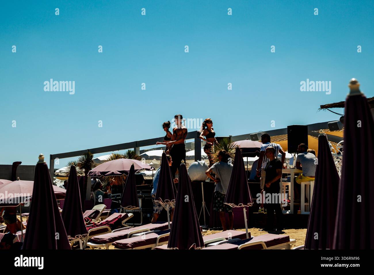 Security staff and beachgoers on the shoreline in St-Tropez, France ...