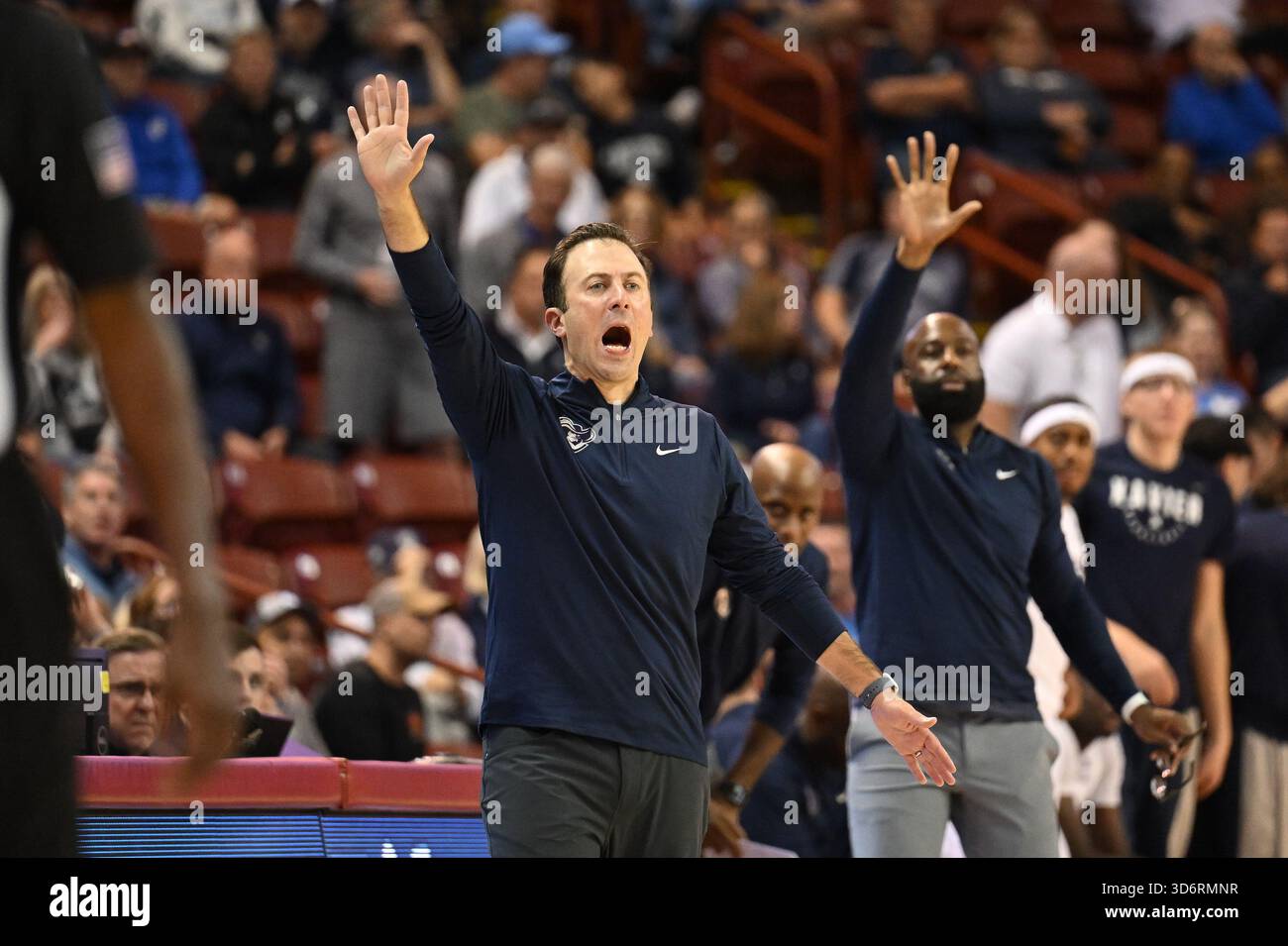 November 21, 2025; Richard Pitino of the Xavier Musketeers holds up his ...