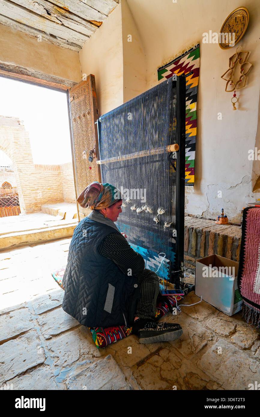 Artisan weaving a carpet on a traditional handloom within the ancient ...