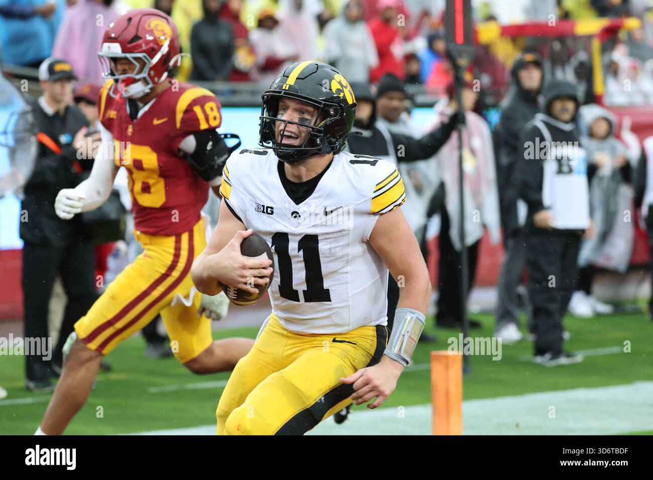 Iowa quarterback Mark Gronowski (11) smiles as he runs into the end ...