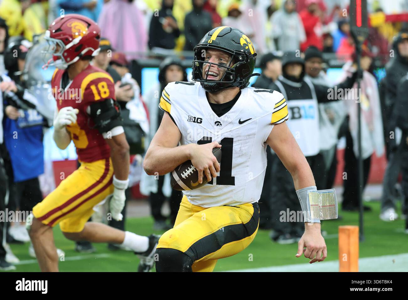 Iowa quarterback Mark Gronowski (11) smiles as he runs into the end ...