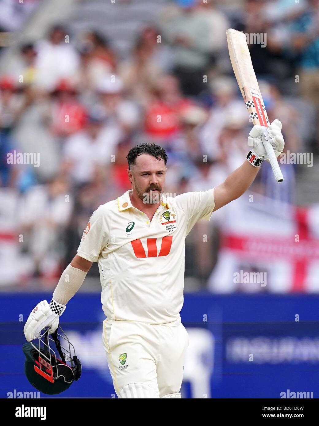Australia's Travis Head raises his bat after scoring a century on day ...