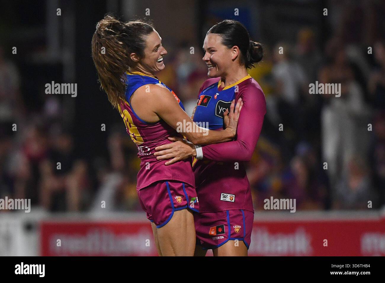 Ruby Svarc of the Lions (left) celebrates a goal with Sophie Conway ...