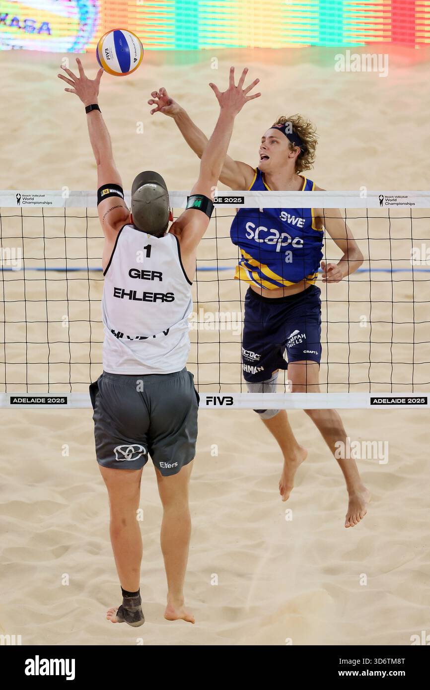 David Åhman of Sweden spikes the ball against Nils Ehlers of Germany in ...