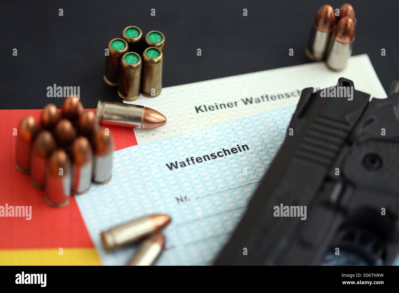 German firearms licenses and handgun with bullets on Germany flag close ...