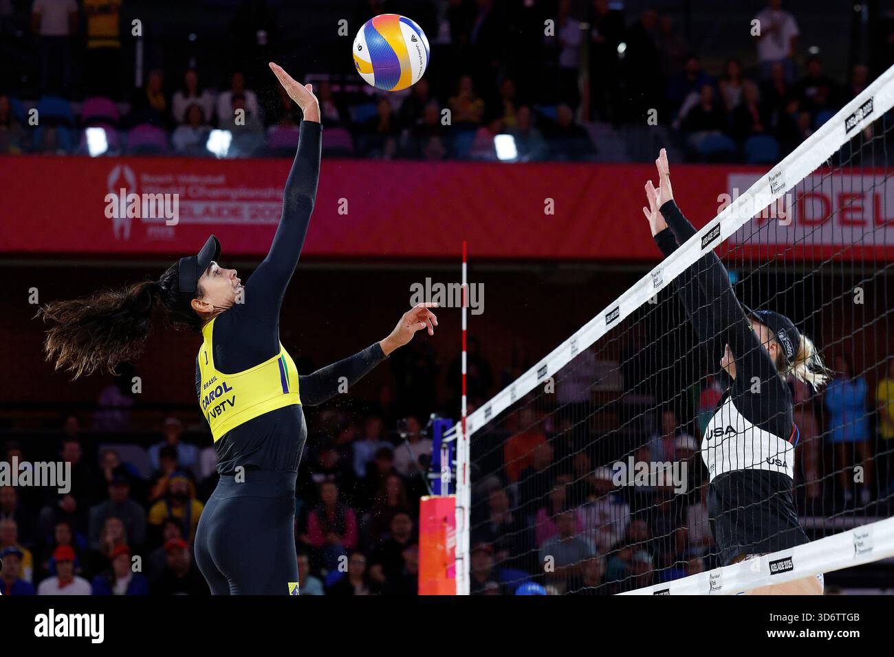 Carolina Solberg Salgado of Brazil spikes the ball against Taryn ...
