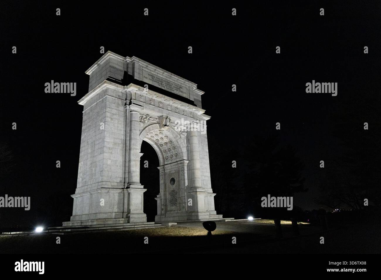 The great National Monument Arch in the middle is lit up at night. The ...
