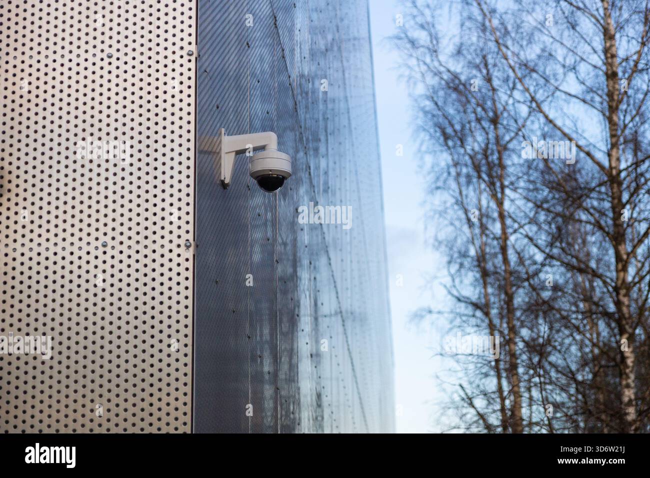 A surveillance security camera installed on the exterior wall of a ...