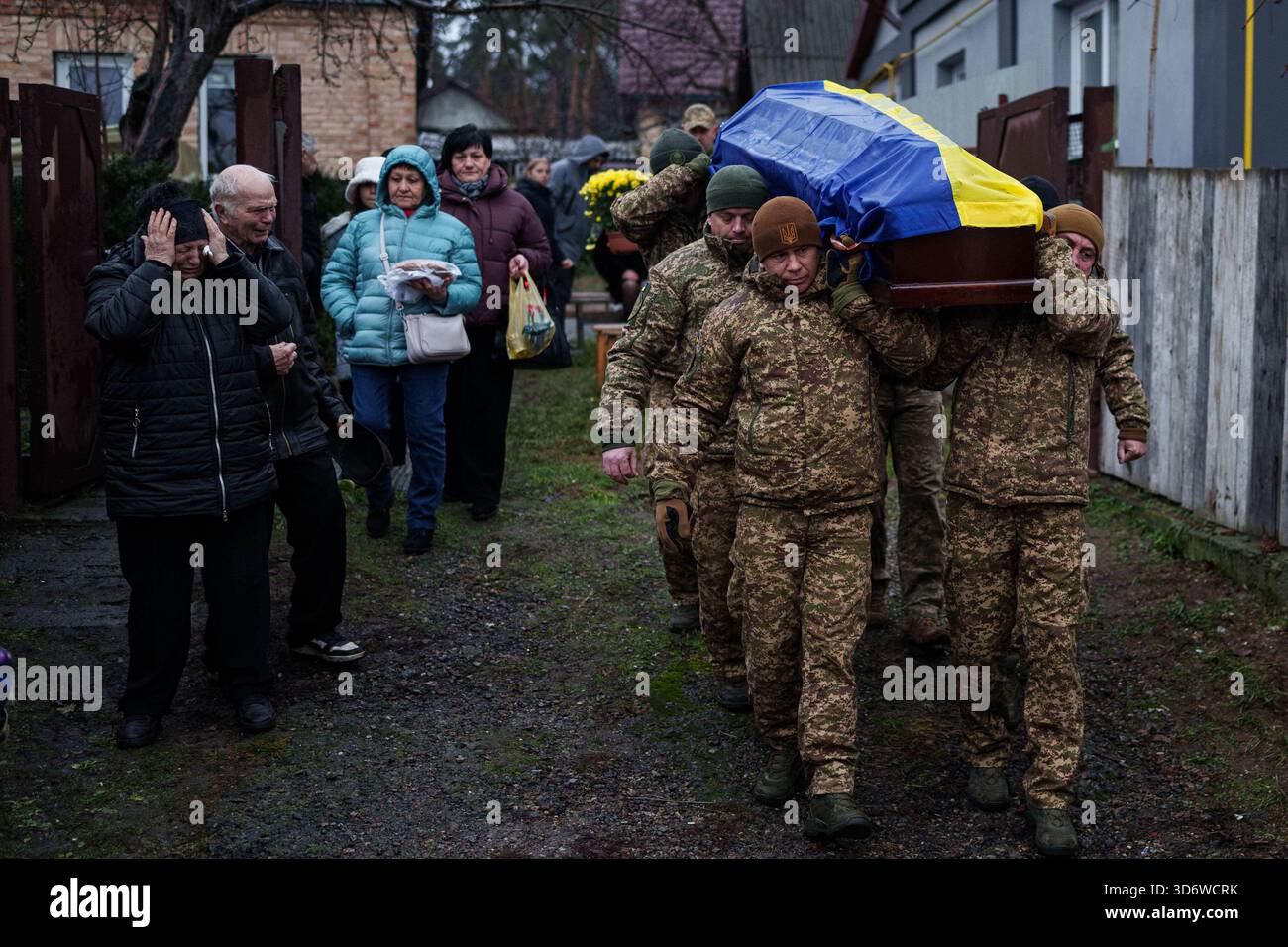 An honor guard carries the coffin of Ruslan Zhygunov, a Ukrainian ...