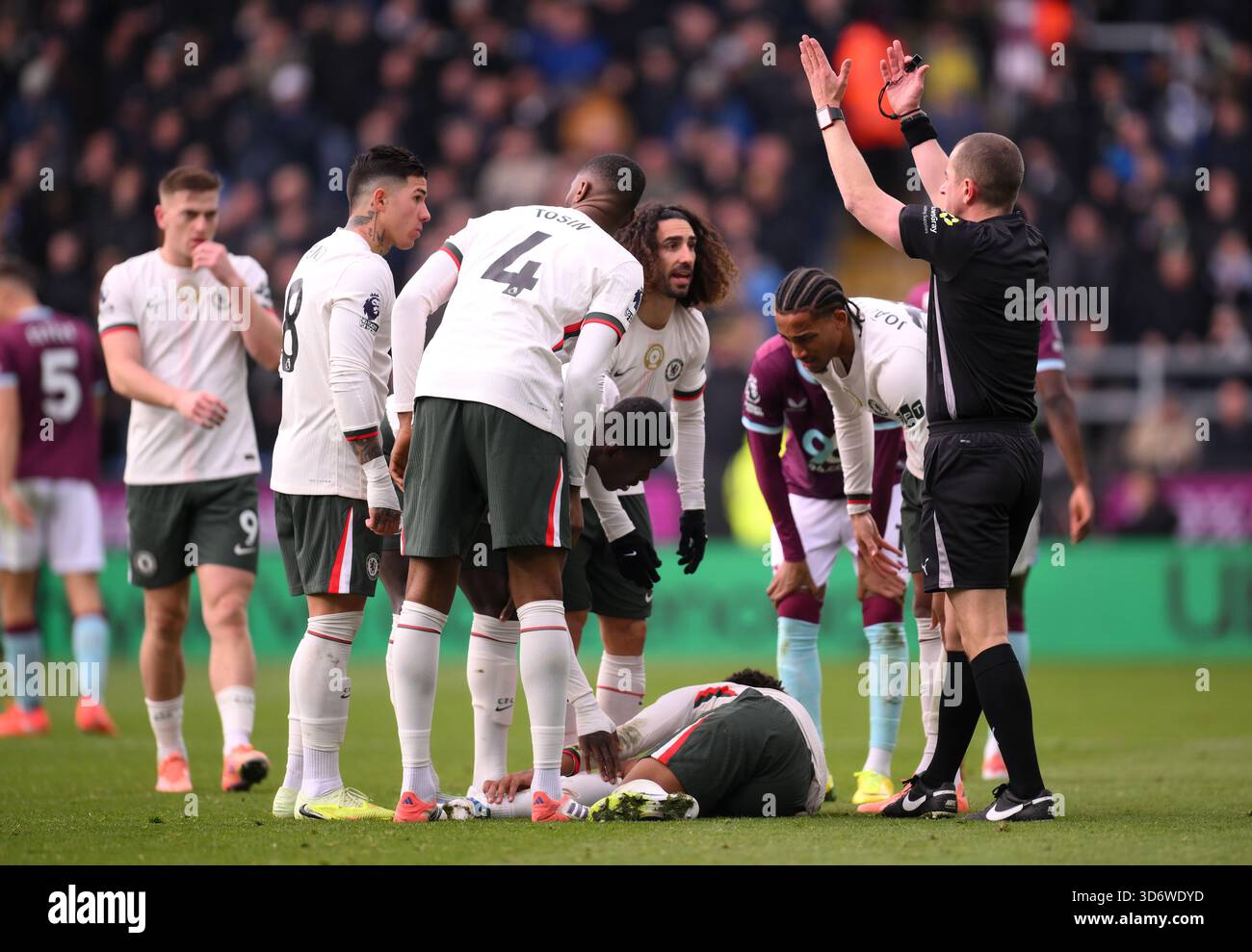 Chelsea's Andrey Santos appears injured as referee Peter Bankes and ...