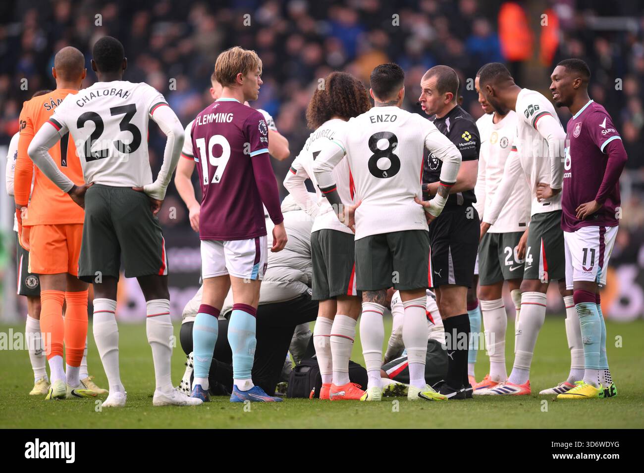 Chelsea's Andrey Santos receives treatment as referee Peter Bankes and ...