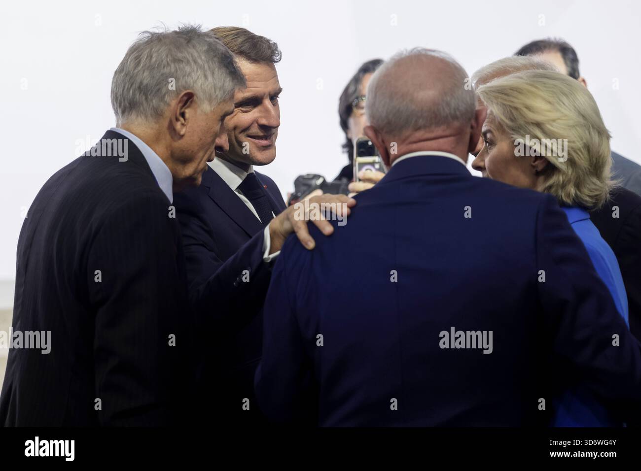 France's President Emmanuel Macron, second left, speaks to delegates ...