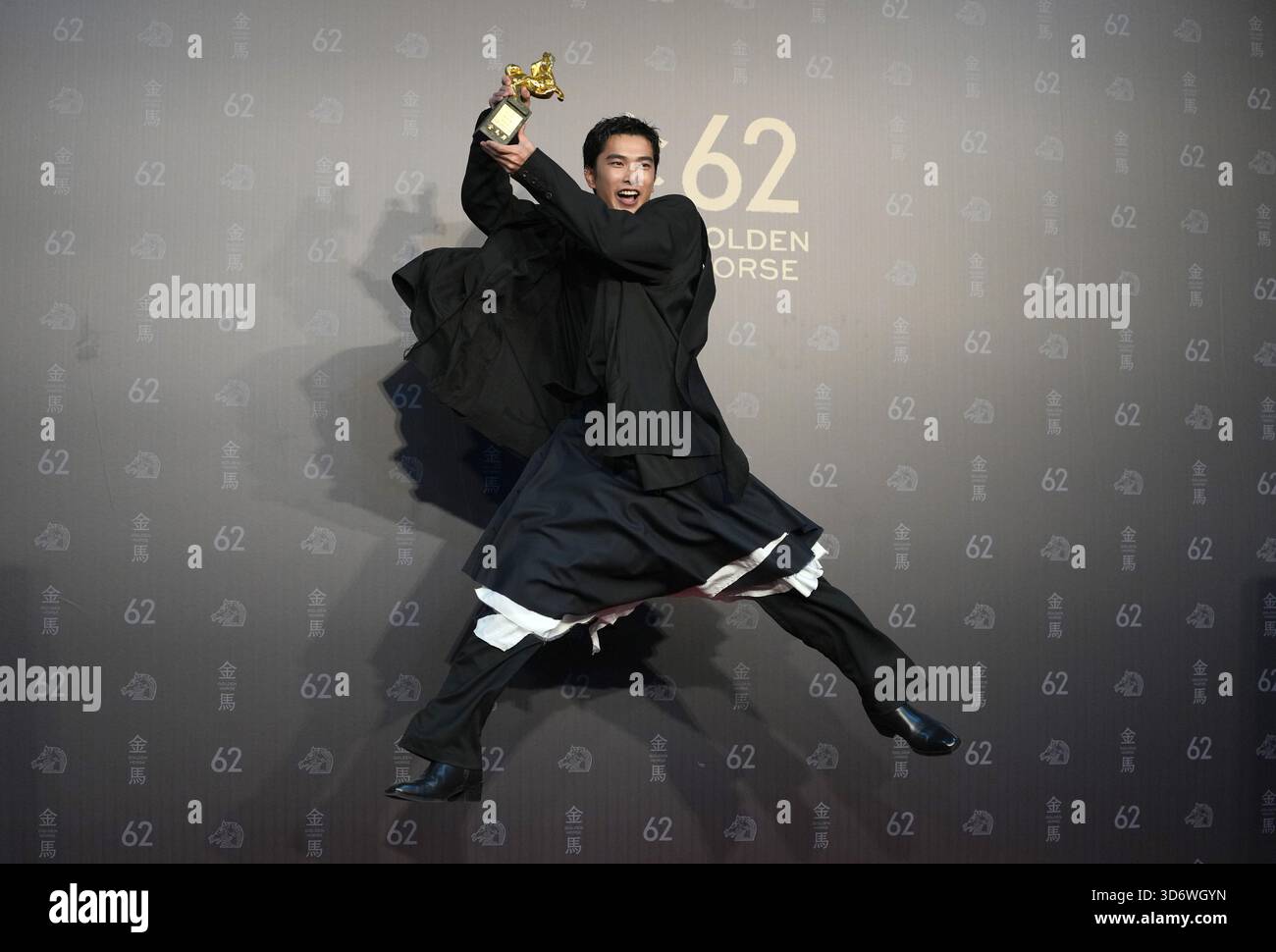 Tseng Jing-hua holds his award for Best Supporting Actor for the film ...