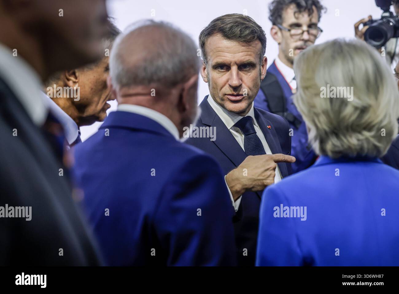 France's President Emmanuel Macron, center, speaks to delegates ahead ...