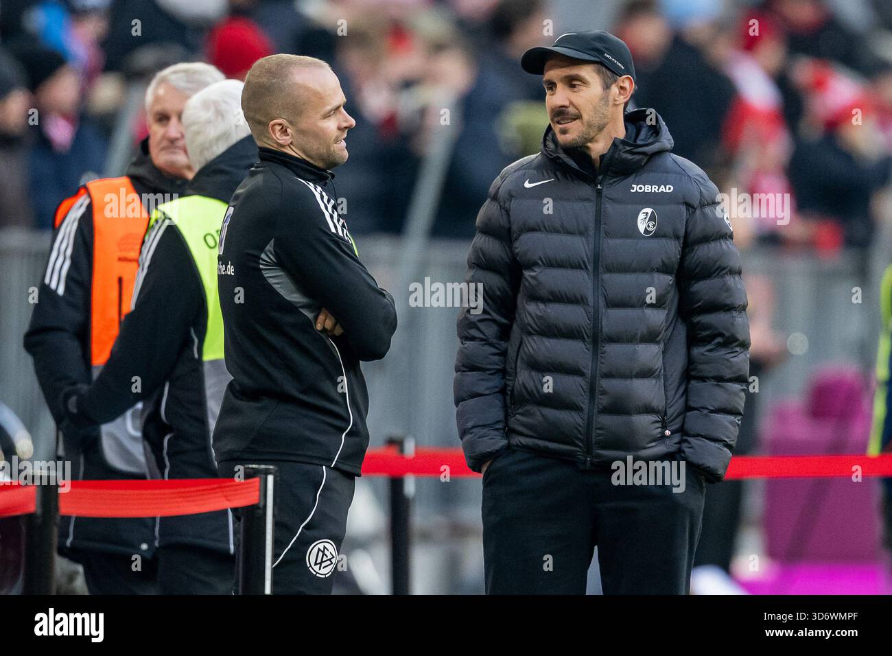 Julian Schuster (Head Coach [coach], Freiburg) in conversation with Patrick Schwengers (4th ...