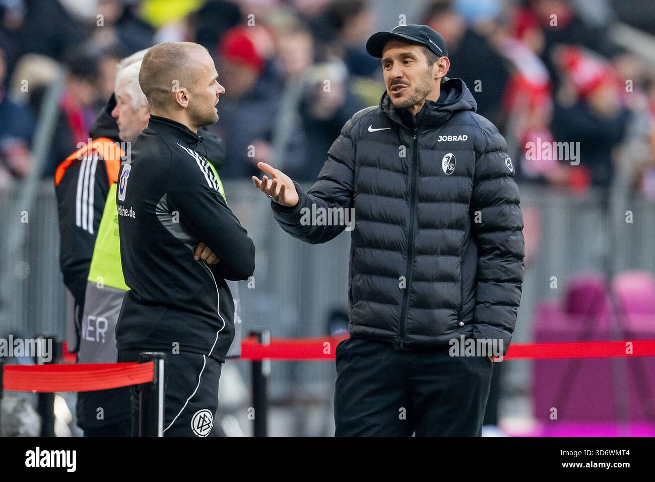 Julian Schuster (Head Coach [coach], Freiburg) in conversation with Patrick Schwengers (4th ...