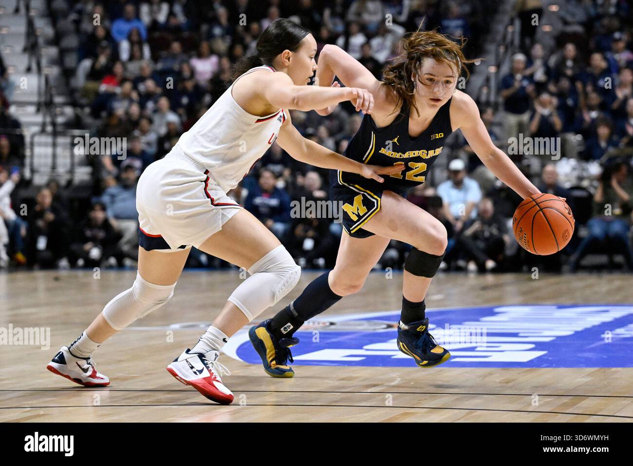 Michigan guard Syla Swords (12) is guarded by UConn guard Kayleigh ...