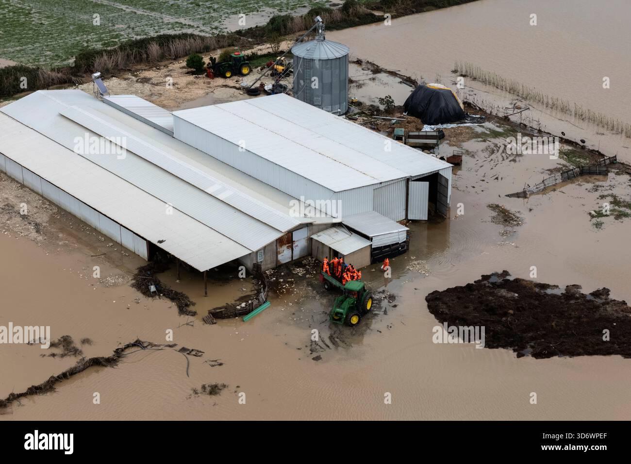 Emergency personnel assist in evacuating a flooded farm after a week of ...
