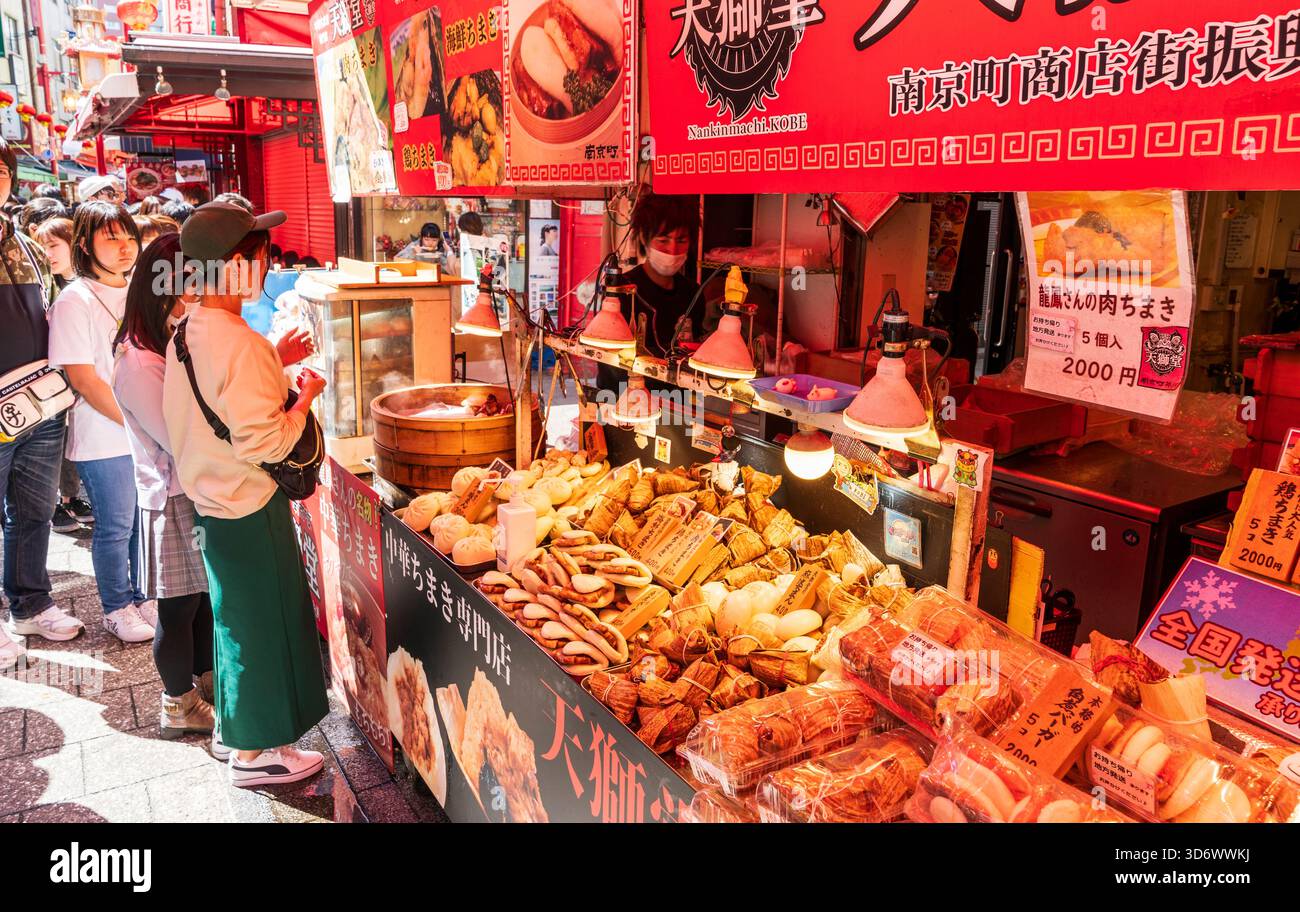 People queuing at a typical food counter stacked with steamed buns ...