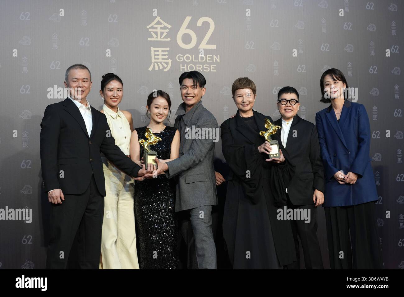 Director Chen Yu-hsun, left, and his team members hold their award for ...