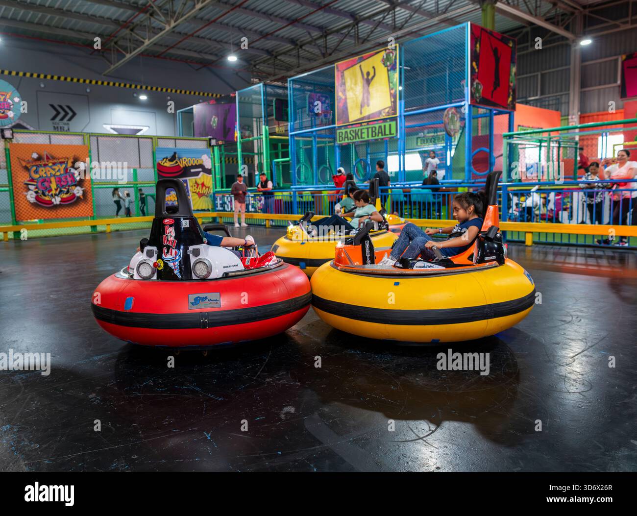 Documentary indoor bumper car arena with children riding circular ...