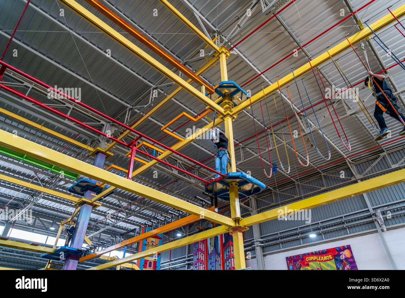 Aerial Rope Course with Harnessed Participants on Elevated Platforms ...